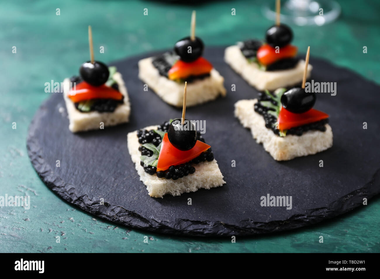 Tasty canapes on slate plate Stock Photo - Alamy