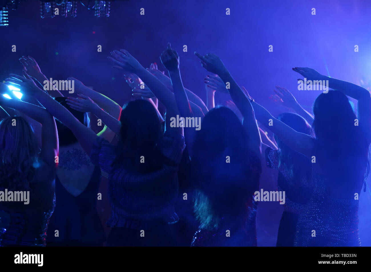 Beautiful young women dancing in night club Stock Photo - Alamy