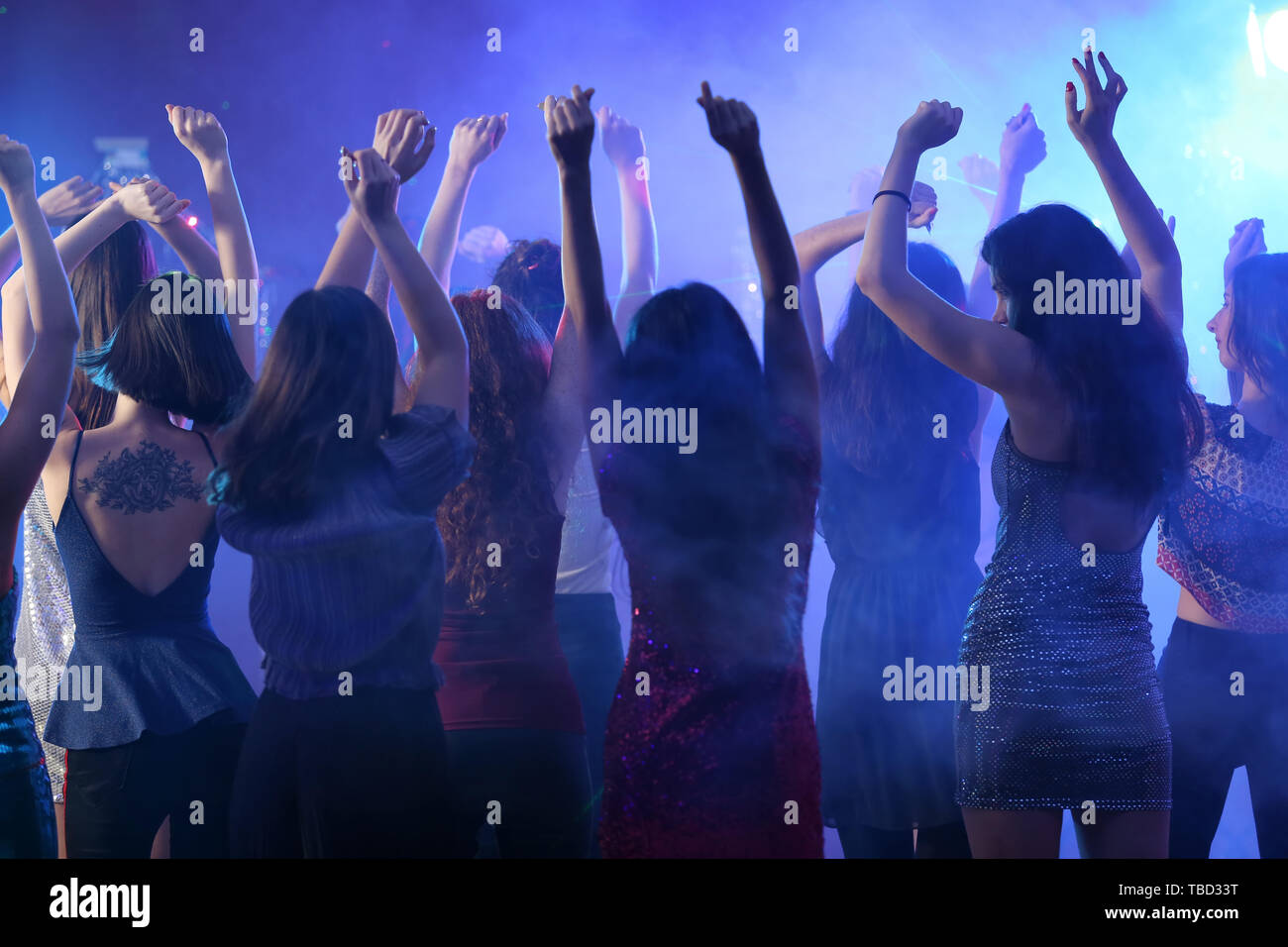 Beautiful young women dancing in night club Stock Photo - Alamy