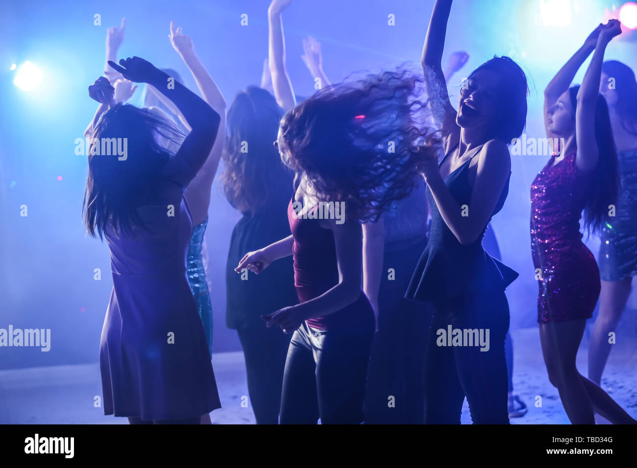Beautiful young women dancing in night club Stock Photo - Alamy