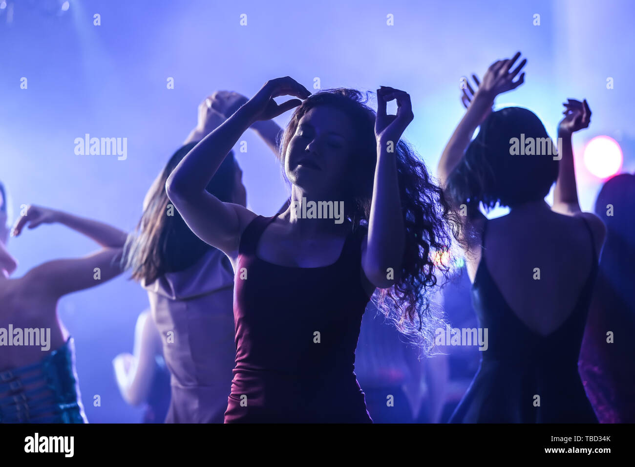 Beautiful young women dancing in night club Stock Photo - Alamy