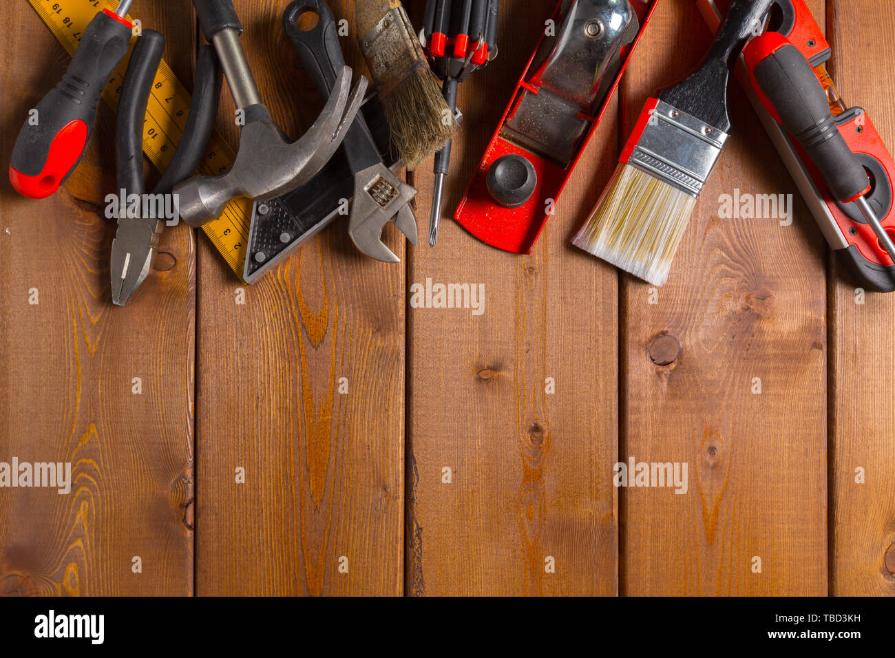 Assorted work tools on wood background Stock Photo - Alamy