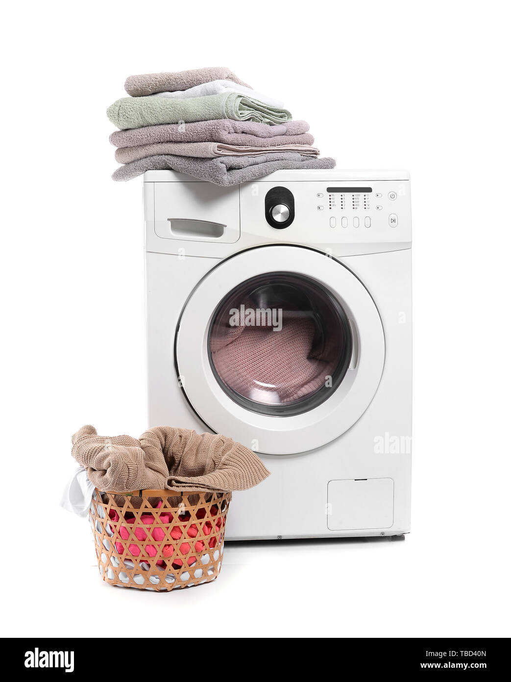Modern washing machine and laundry on white background Stock Photo - Alamy