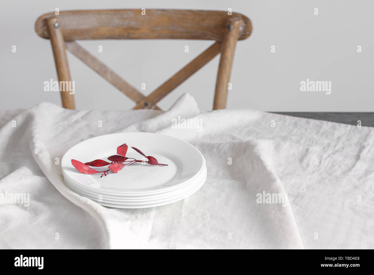 Stack of clean plates on table against light background Stock Photo - Alamy