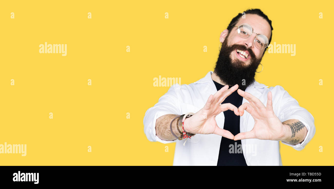 Doctor therapist man with long hair and bear wearing white coat smiling ...