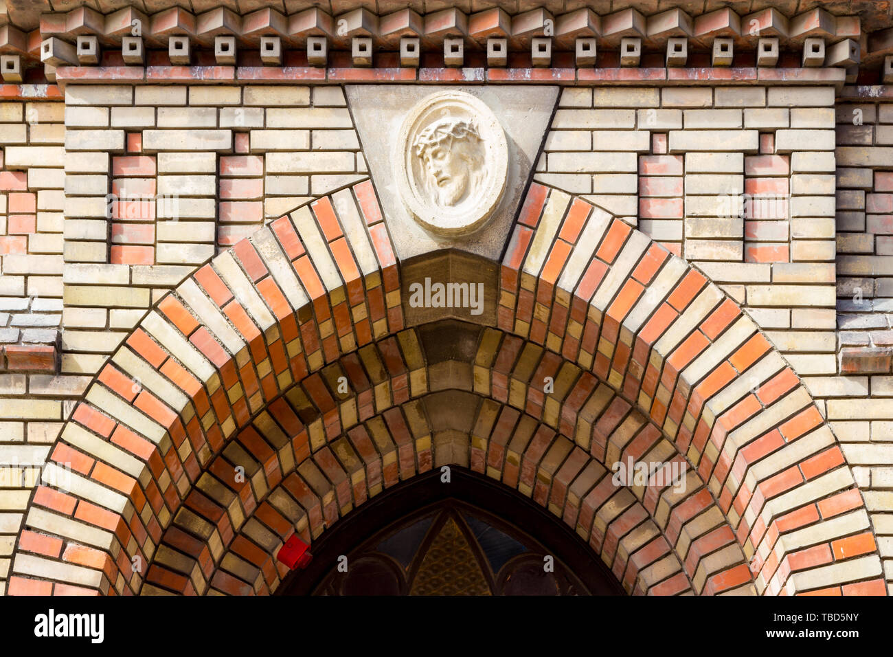 Jesus Christ head relief as keystone of 19th century brick gate Stock ...