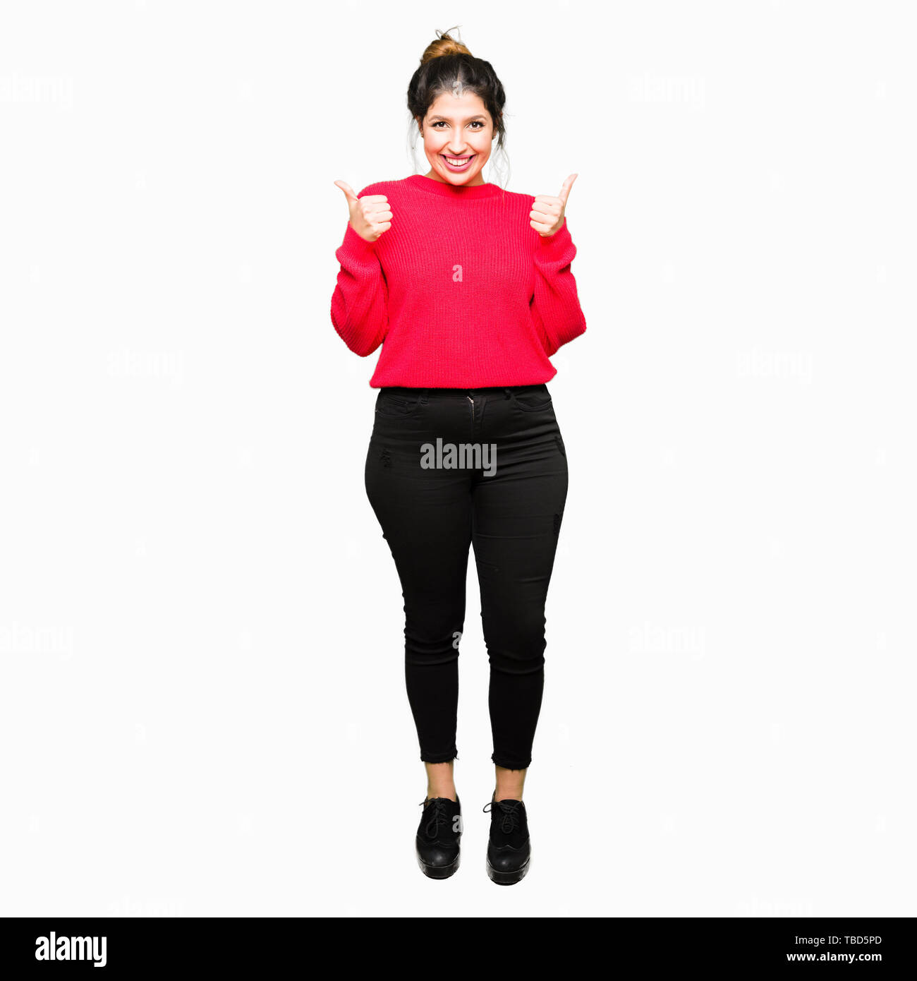 Young Beautiful Woman Wearing Red Sweater And Bun Success Sign Doing