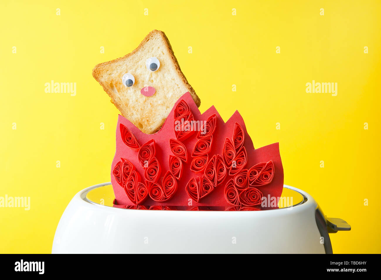 Funny composition with slice of bread and toaster on color background ...