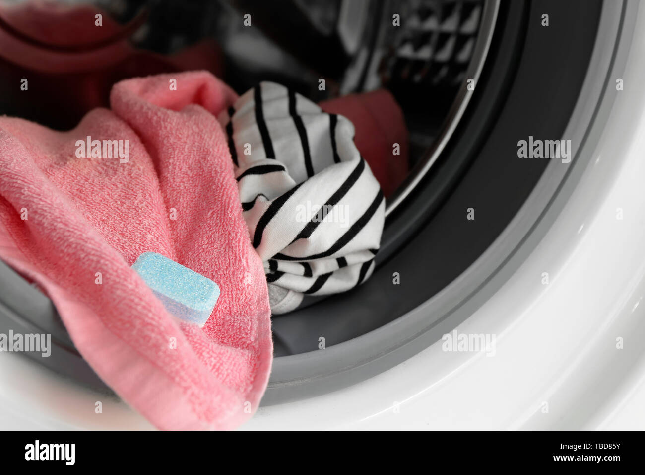 Washing machine with laundry and detergent, closeup Stock Photo - Alamy