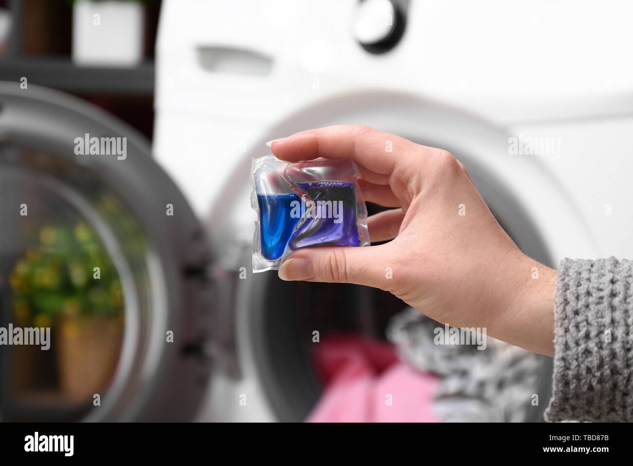Female hand with detergent pod for laundry, closeup Stock Photo - Alamy