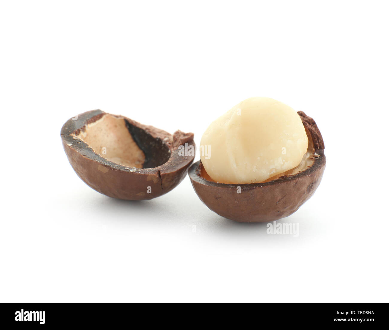 Cracked macadamia nut on white background Stock Photo - Alamy