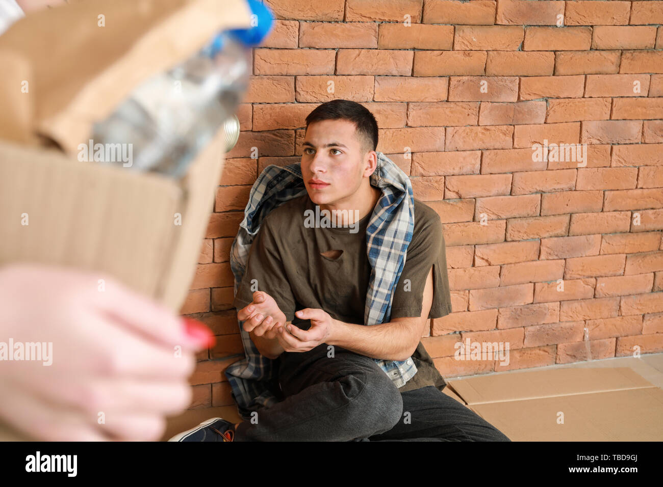 Poor man asking volunteers to give him food Stock Photo - Alamy