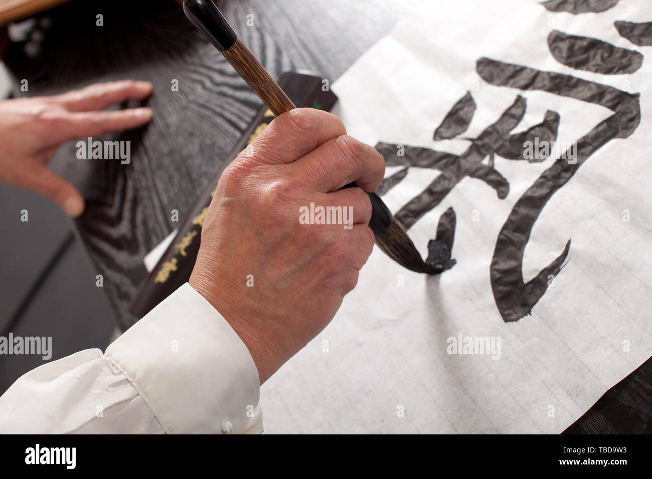 An old man practicing calligraphy Stock Photo - Alamy