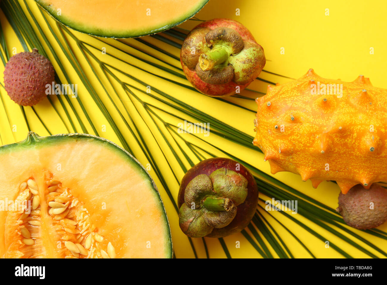 Assortment of tasty exotic fruits on color background Stock Photo - Alamy