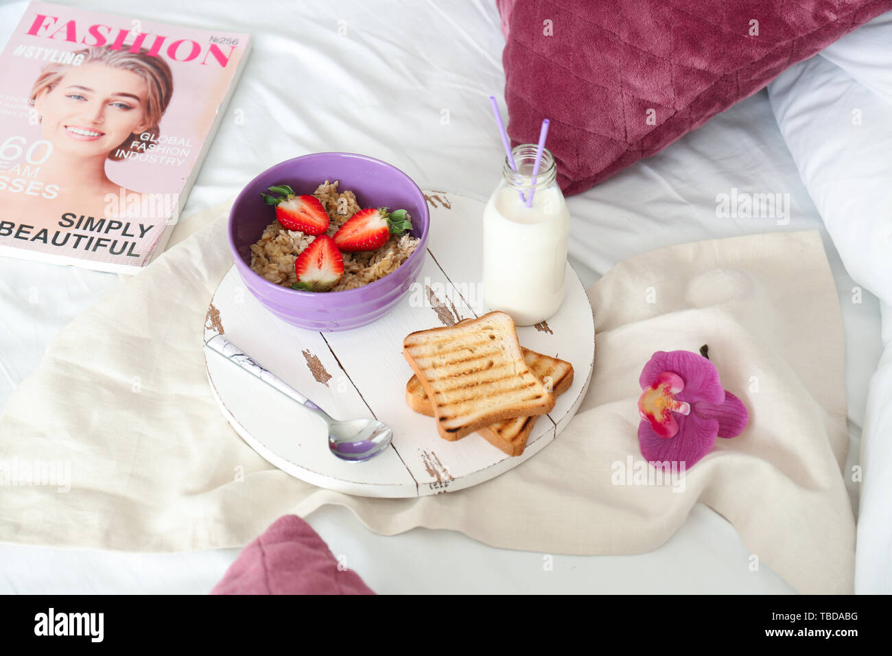 Tray with healthy breakfast and magazine on bed Stock Photo - Alamy