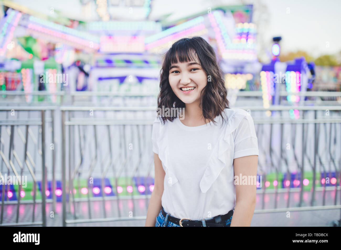 Beautiful asian girl in an amusement park, smiling. Copy space Stock ...