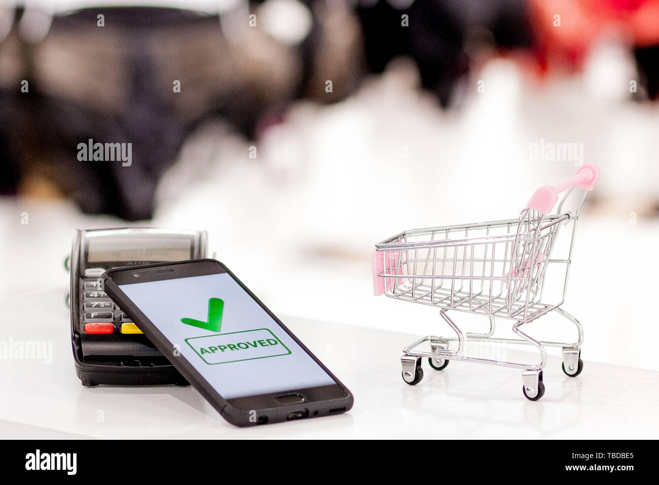 POS terminal, Payment Machine with mobile phone on store background ...