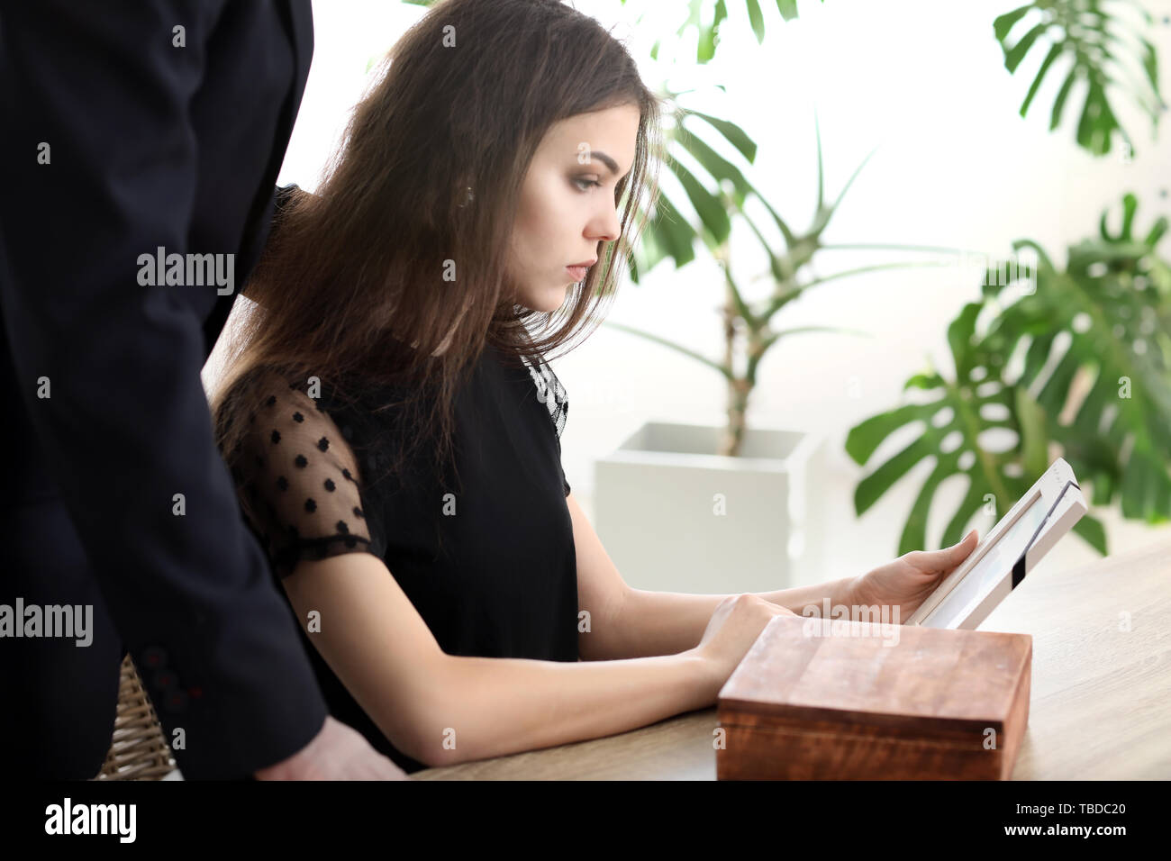 Couple pining after their relative at home Stock Photo - Alamy