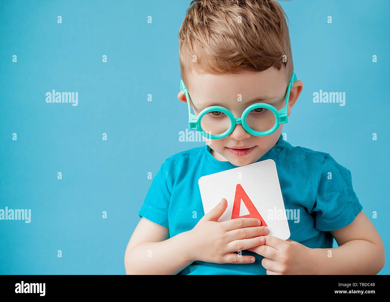 Cute little boy with letter on background. Child learn letters ...