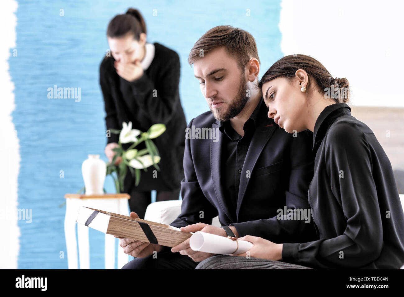Couple pining after their relative at funeral Stock Photo - Alamy