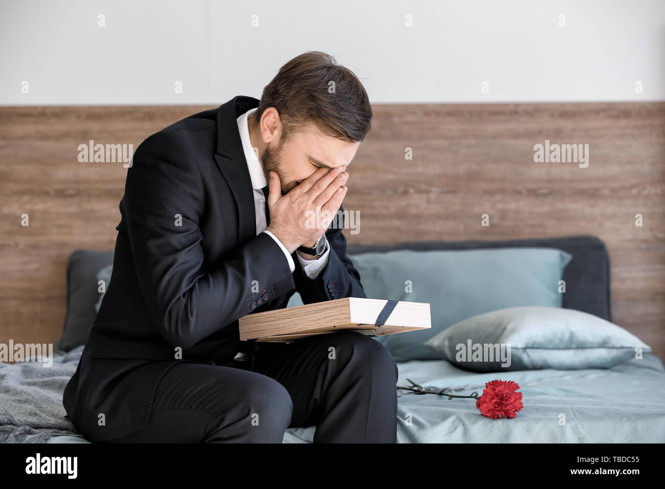 Man pining after his relative after funeral Stock Photo - Alamy