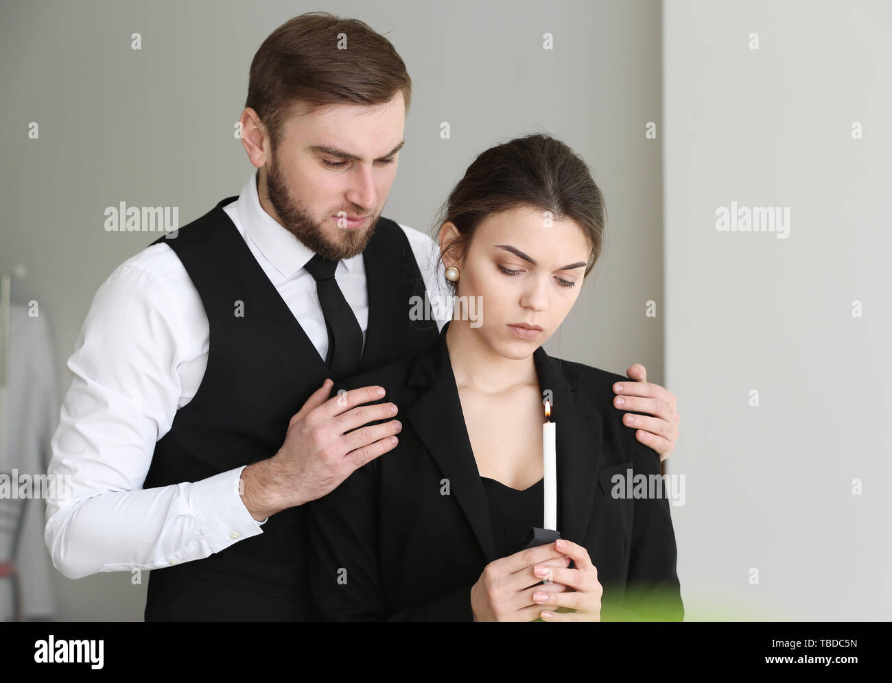 Couple pining after their relative at funeral Stock Photo - Alamy