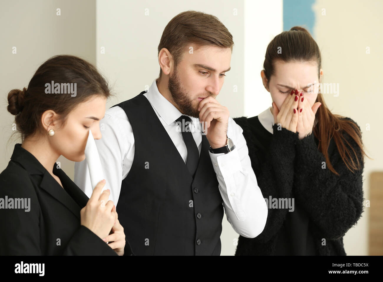 Pining relatives at funeral Stock Photo - Alamy