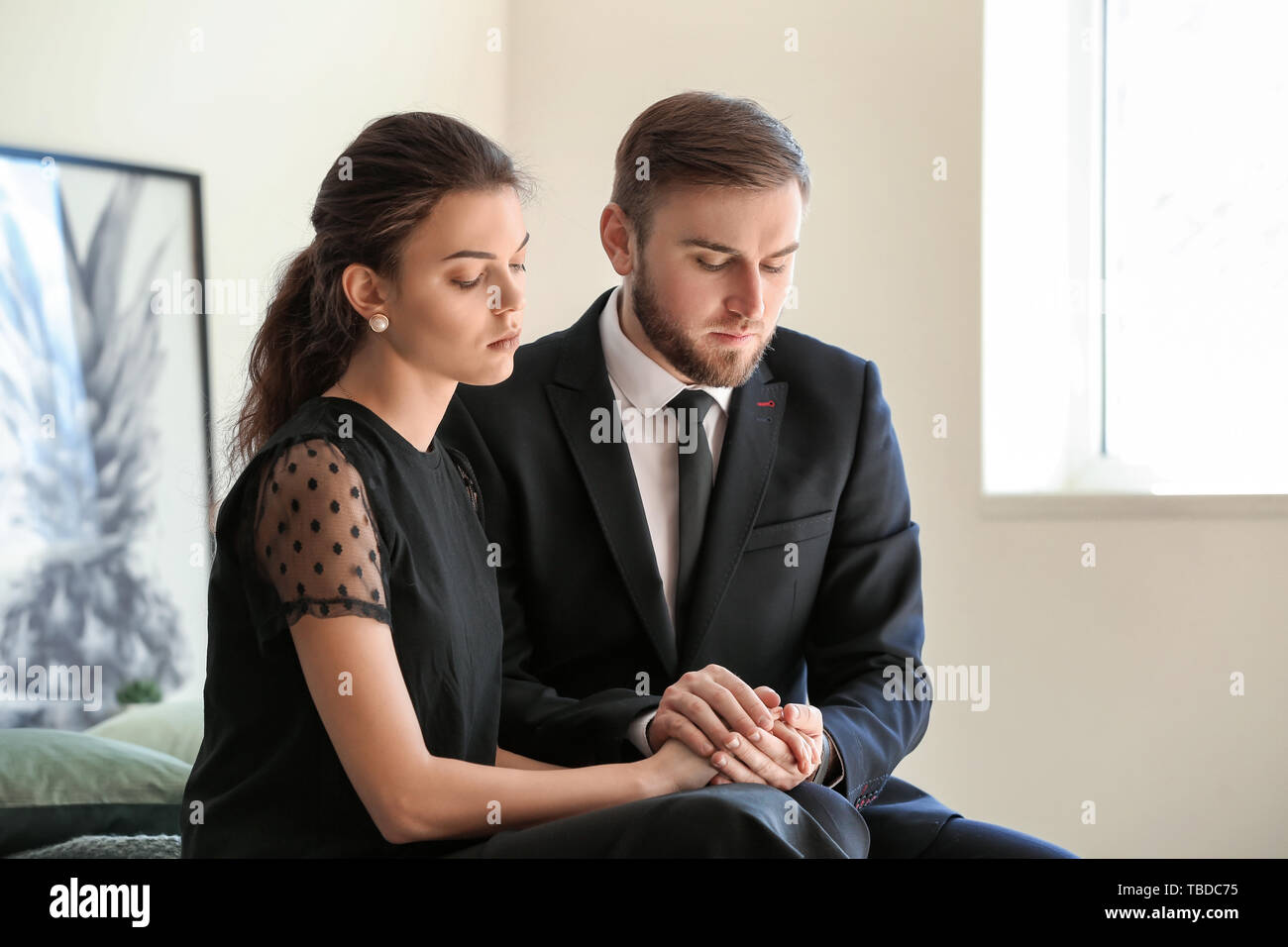 Couple pining after their relative after funeral Stock Photo - Alamy