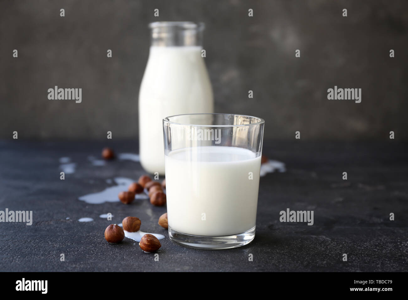 Glass of healthy hazelnut milk on table Stock Photo - Alamy