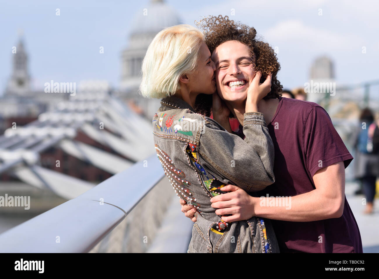 Happy couple hugging by Millennium bridge, River Thames, London Stock ...