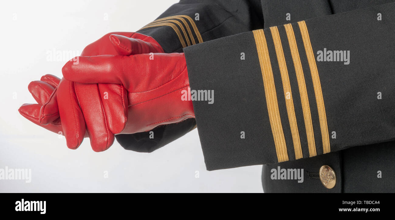 Four gold stripes on a uniform jacket with hands wearing red gloves ...