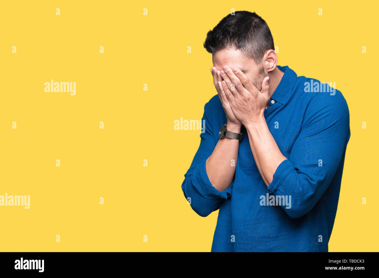 Young handsome man over isolated background with sad expression ...