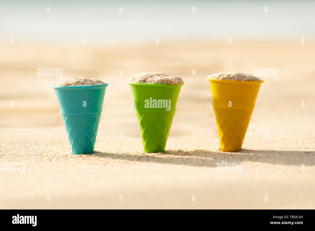 Colorful Cones Filled With Sand Dig On Beach Stock Photo - Alamy