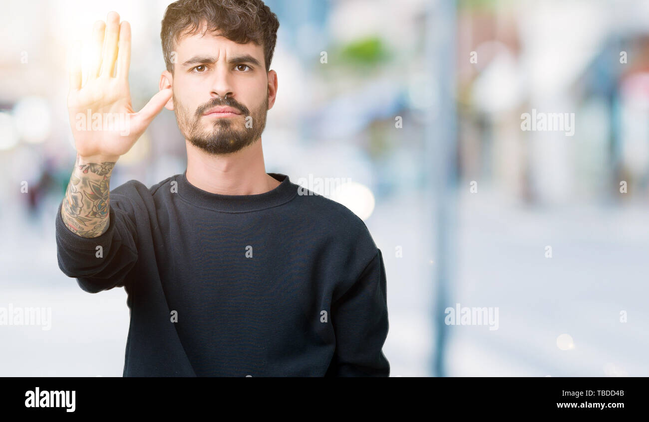 Young handsome man over isolated background doing stop sing with palm ...