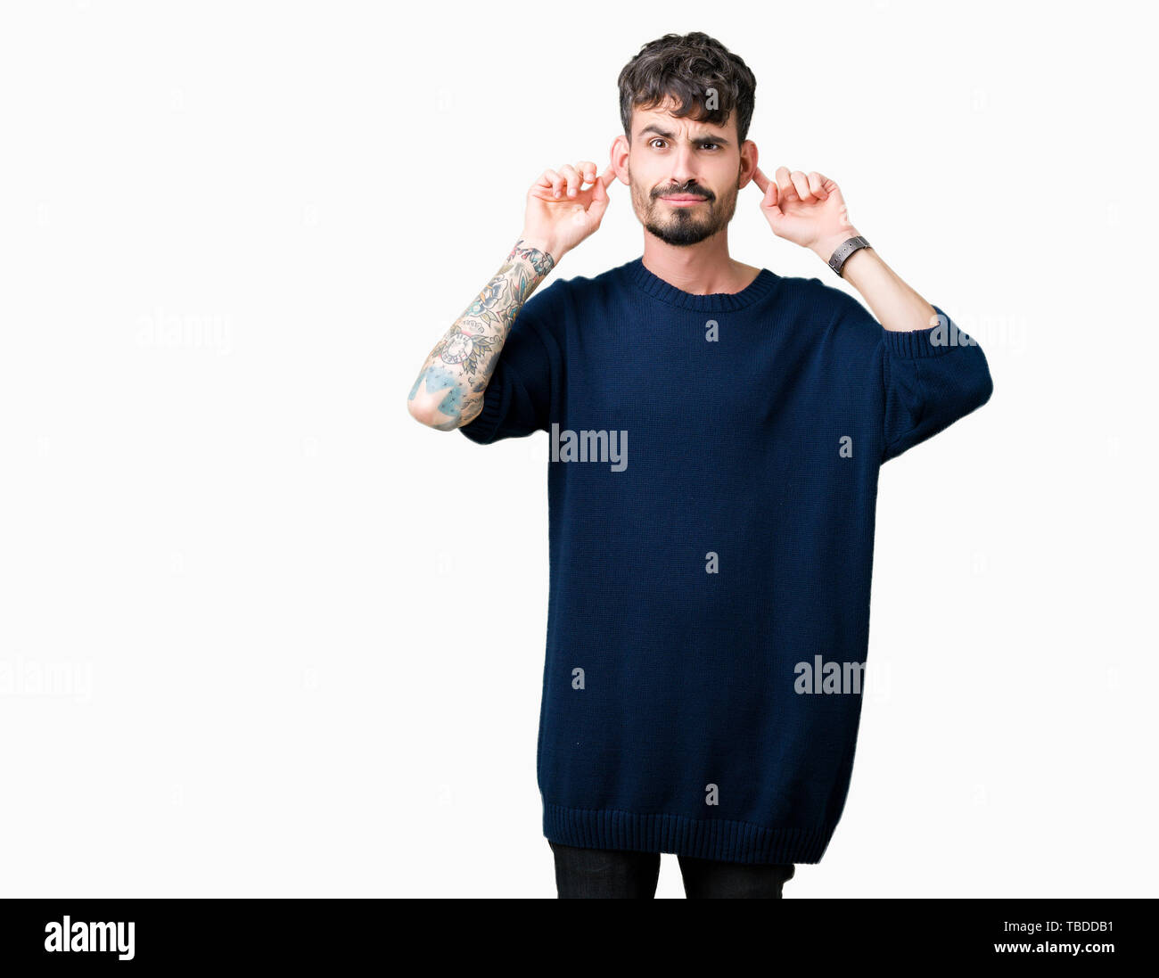Young handsome man over isolated background Smiling pulling ears with ...