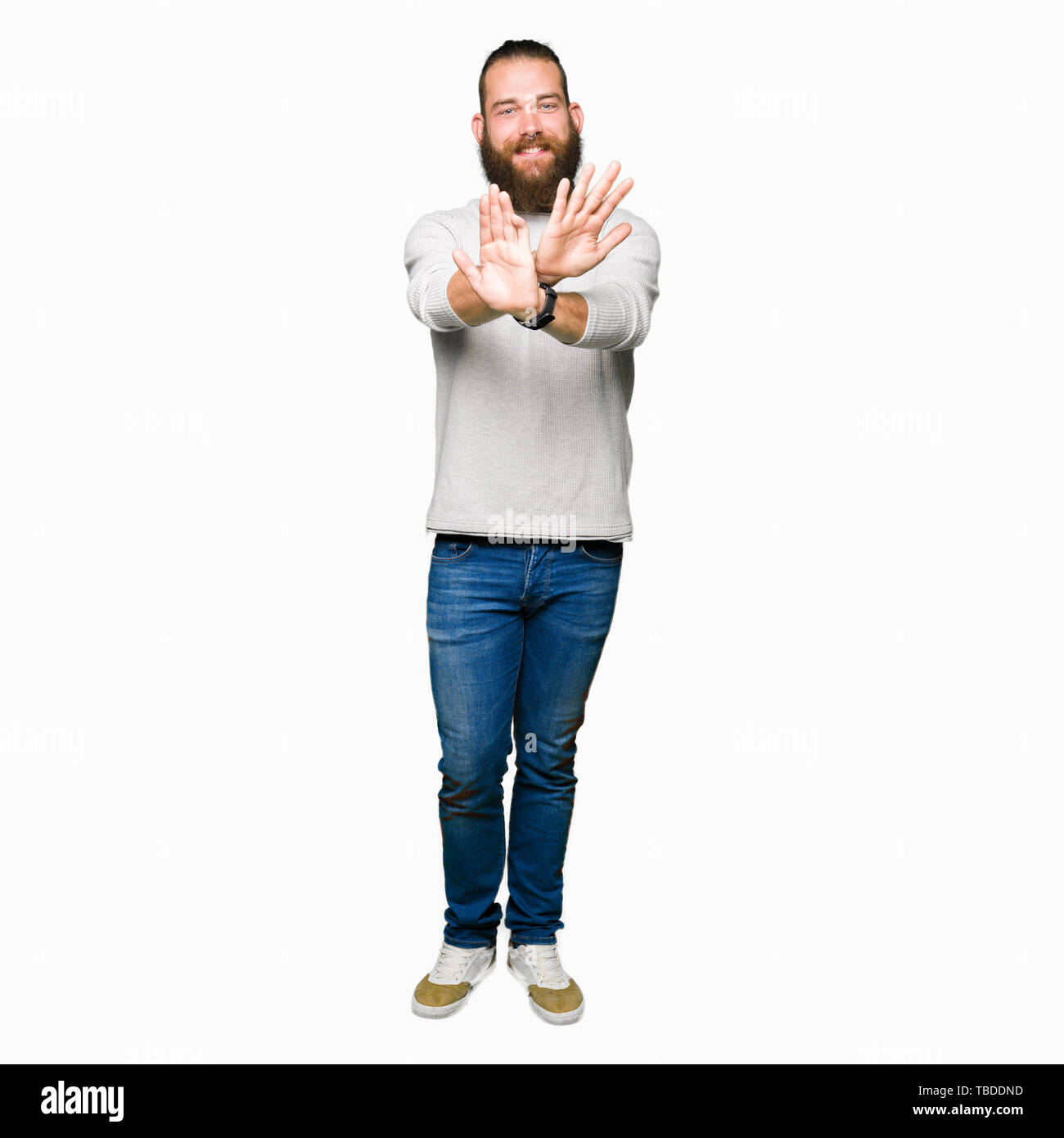 Young blond man wearing casual sweater Rejection expression crossing ...