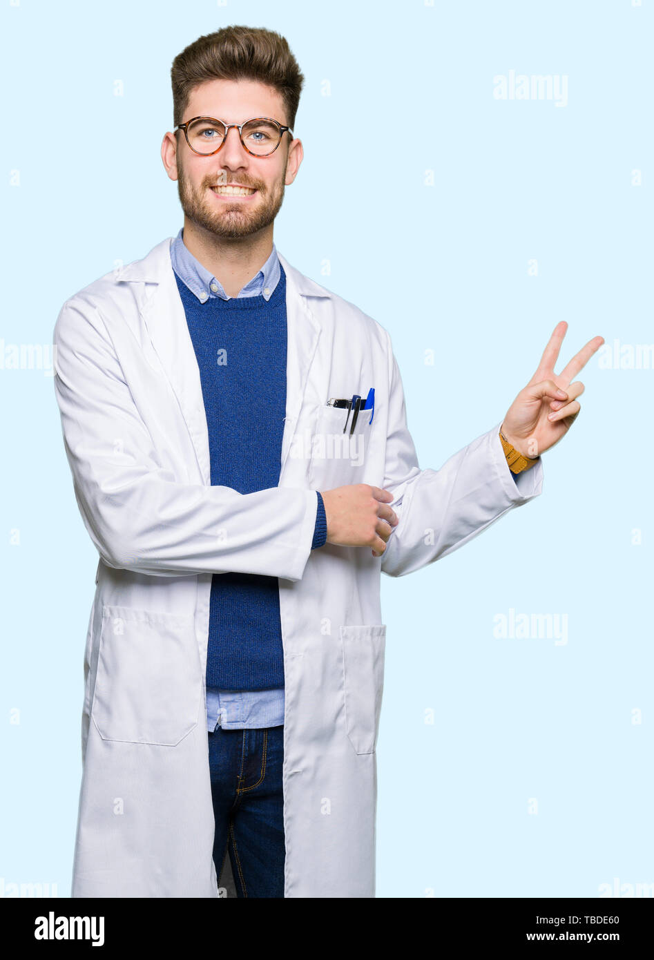 Young handsome scientist man wearing glasses smiling with happy face ...