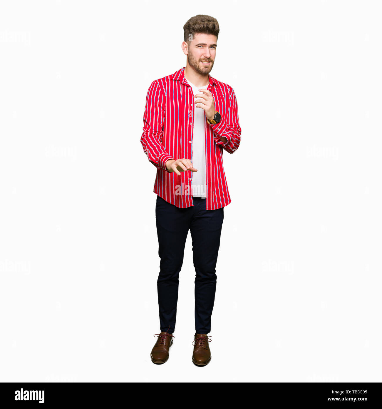 Young handsome man wearing red shirt disgusted expression, displeased ...