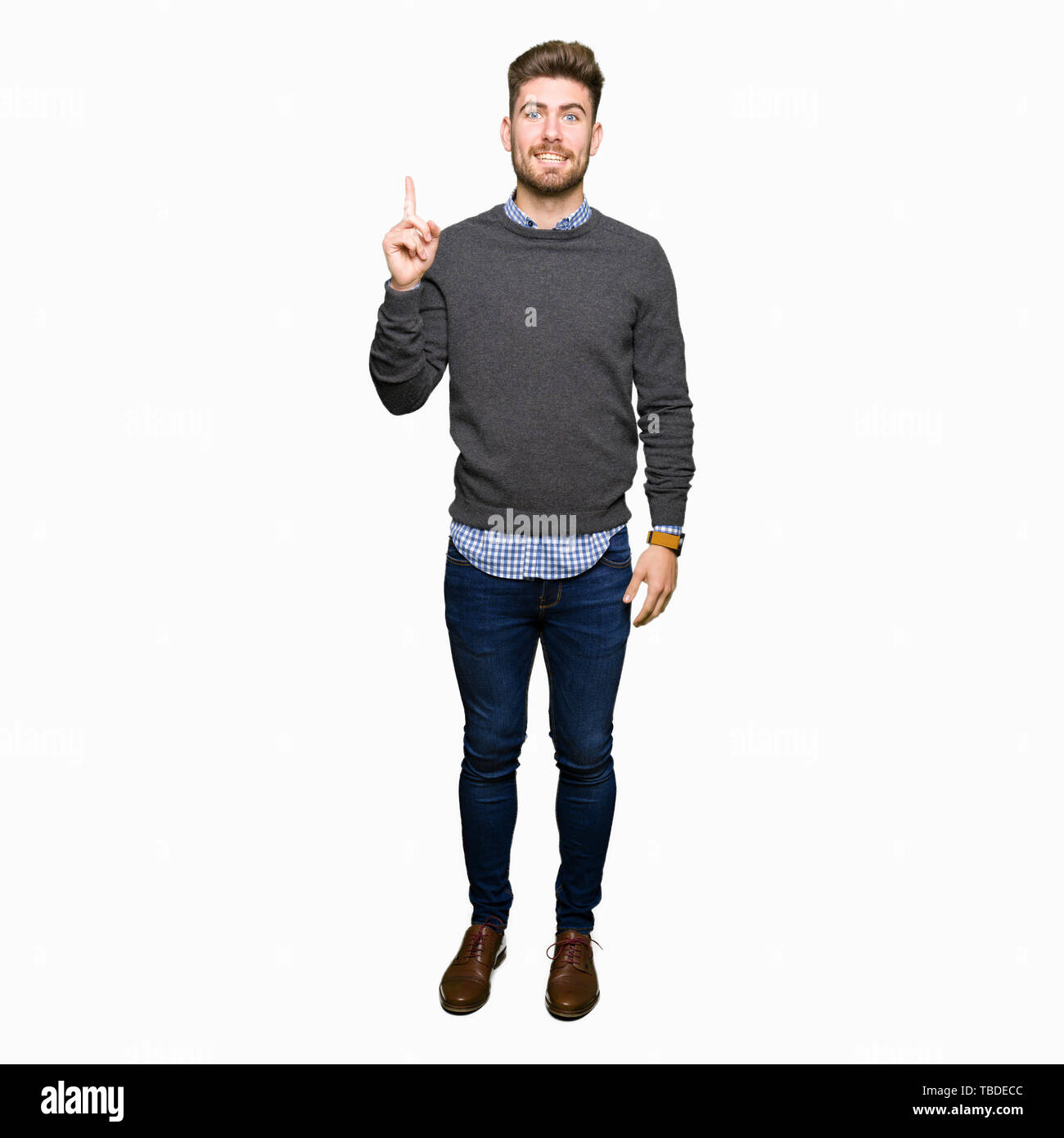 Young handsome elegant man pointing finger up with successful idea ...
