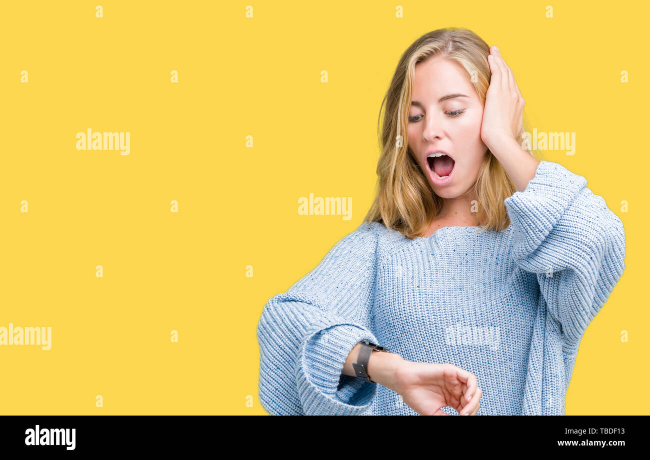Beautiful young woman wearing blue sweater over isolated background ...