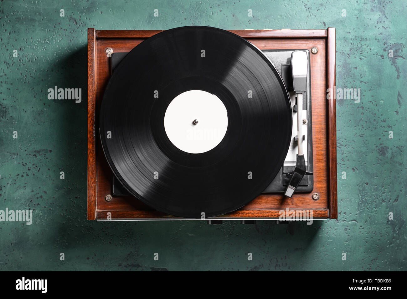 Record player with vinyl disc on color background Stock Photo - Alamy