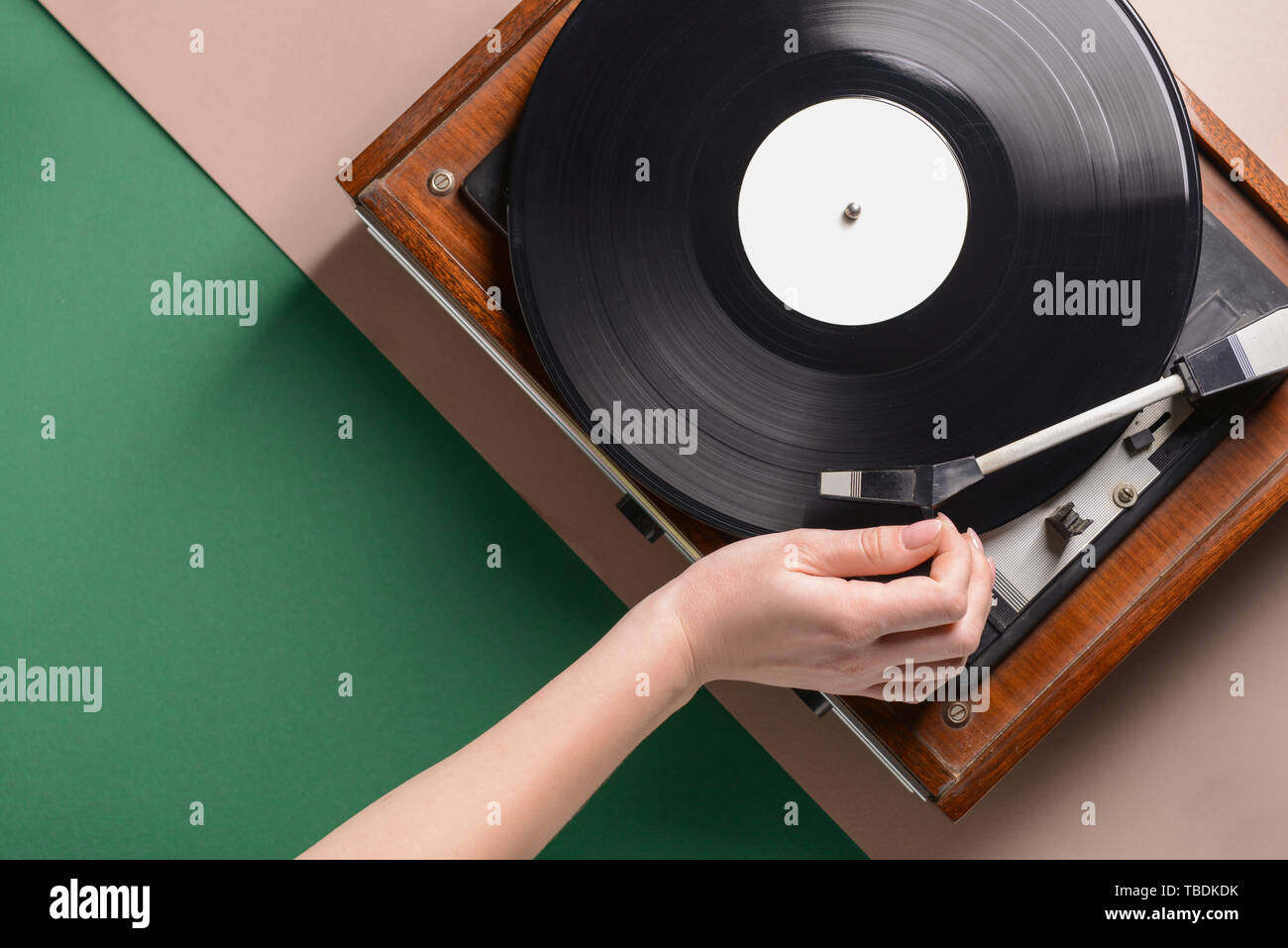 Hand of woman switching on record player with vinyl disc Stock Photo ...