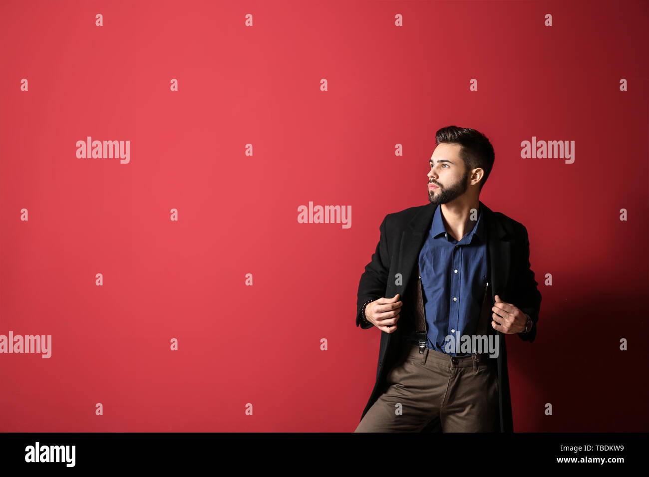 Fashionable young man on color background Stock Photo - Alamy
