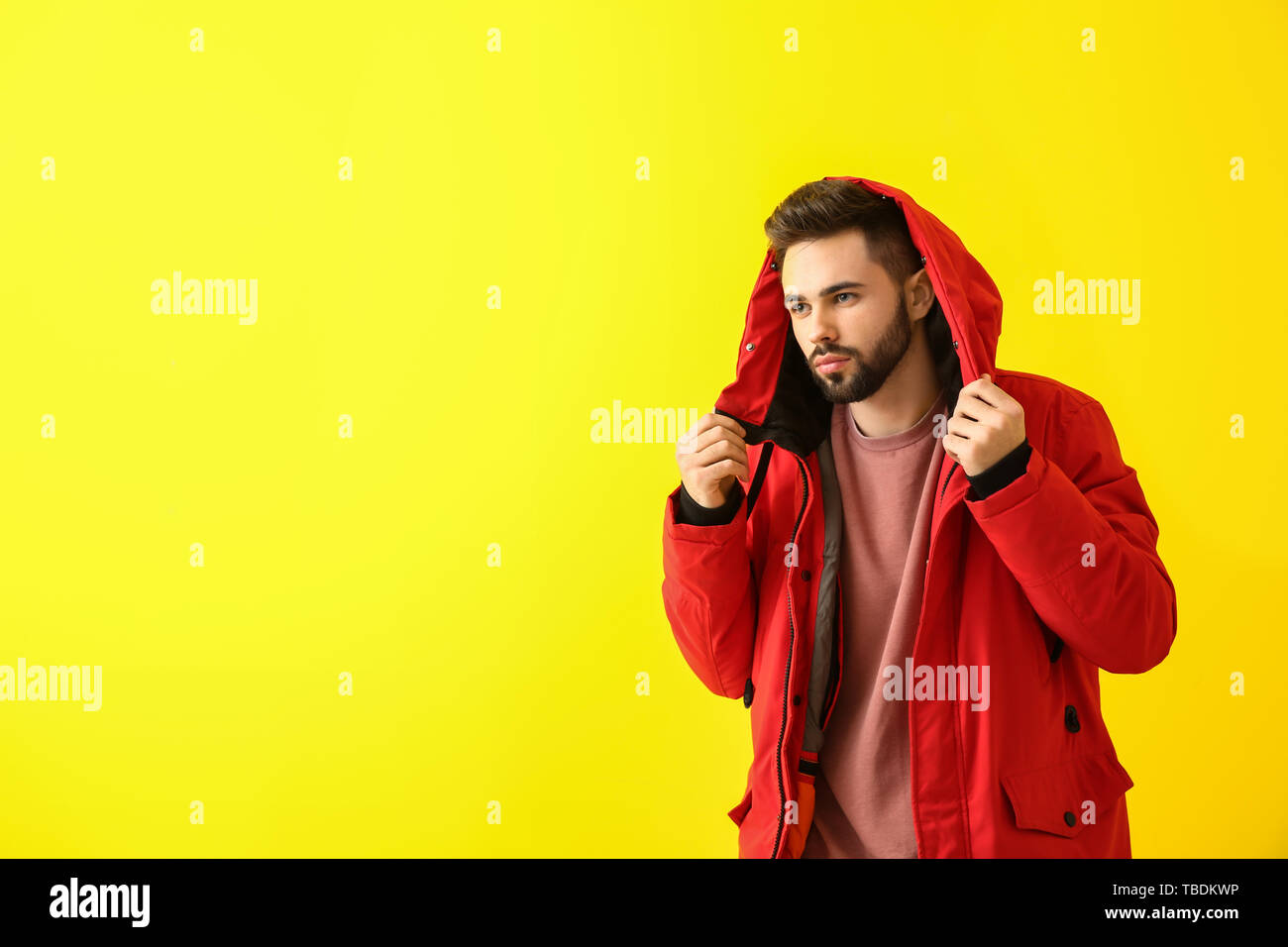 Fashionable young man on color background Stock Photo - Alamy