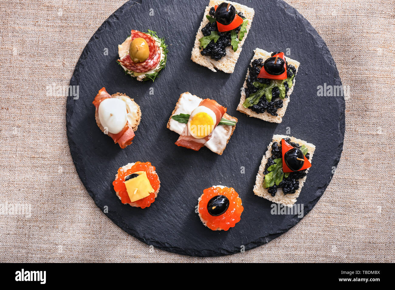 Tasty canapes on slate plate Stock Photo - Alamy