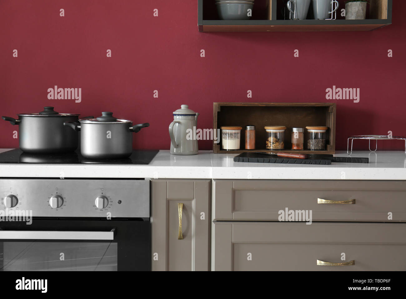 Cookware with spices on counter in modern kitchen Stock Photo - Alamy