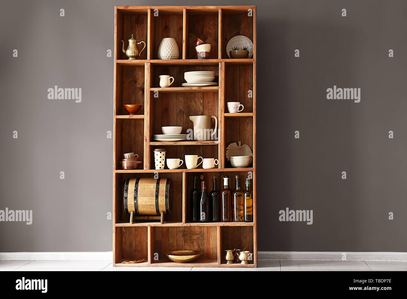 Open cupboard with clean dishes near color wall in kitchen Stock Photo ...