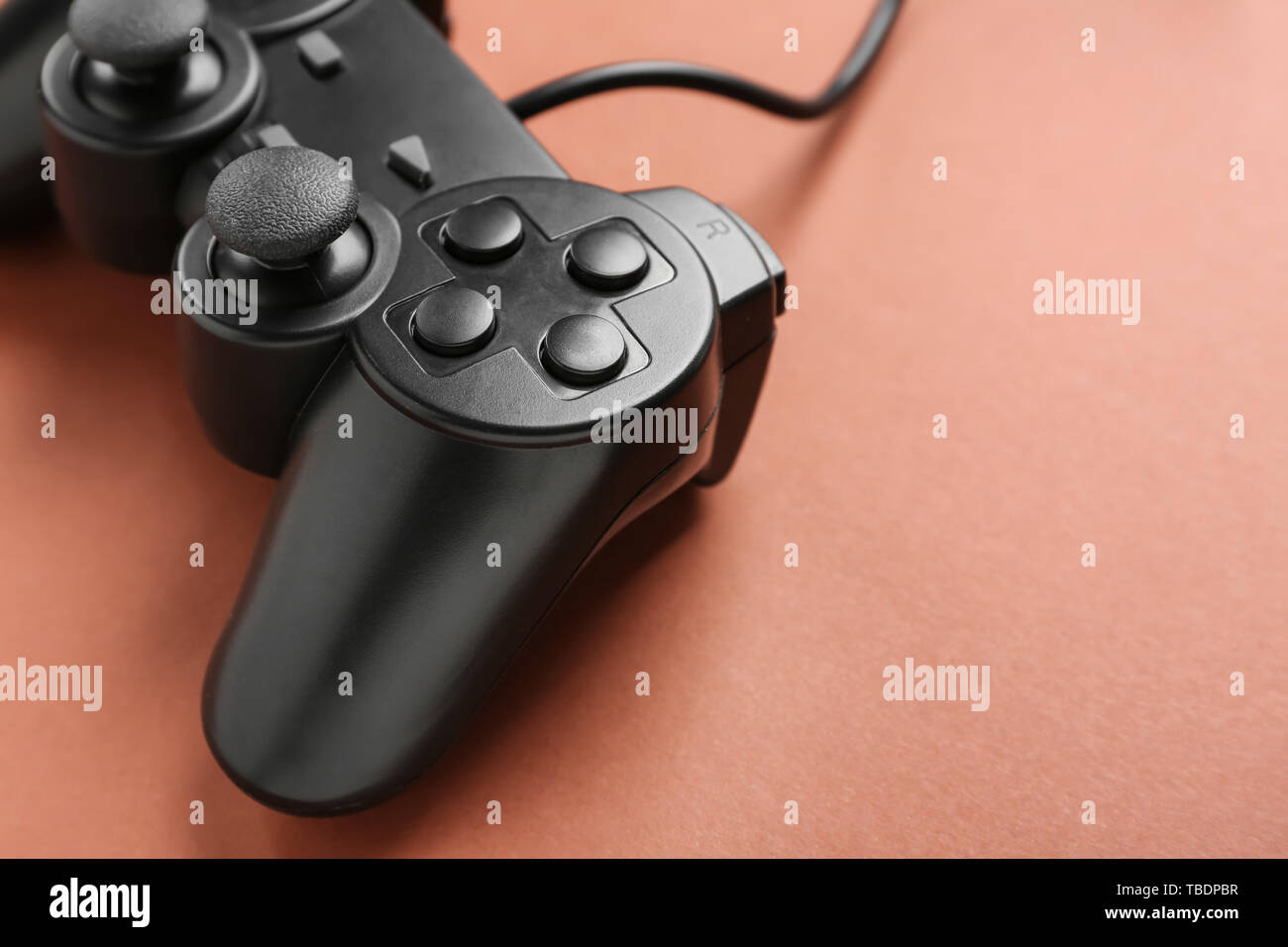 Modern game pad on color background Stock Photo - Alamy