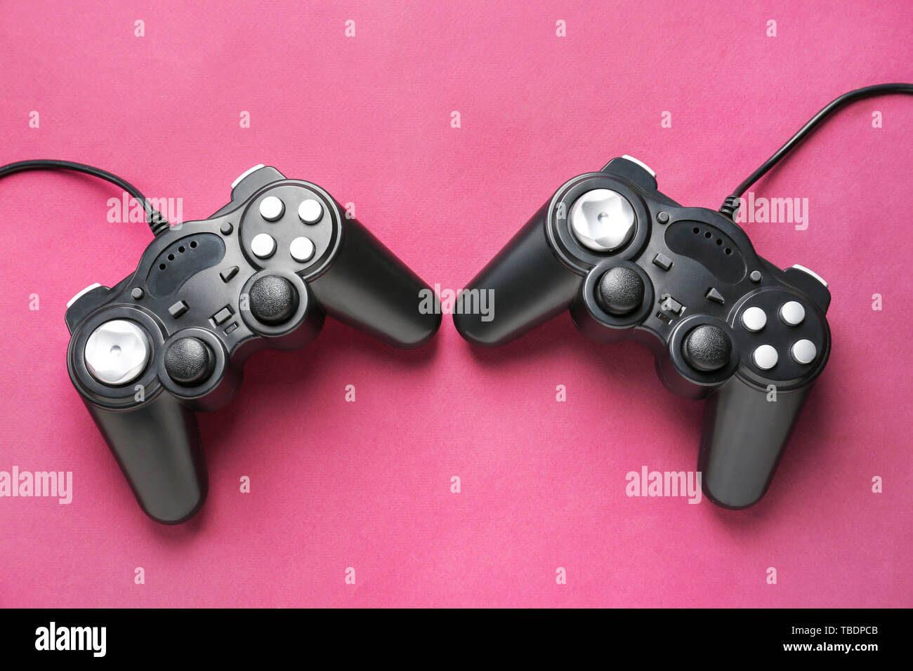 Modern game pads on color background Stock Photo - Alamy