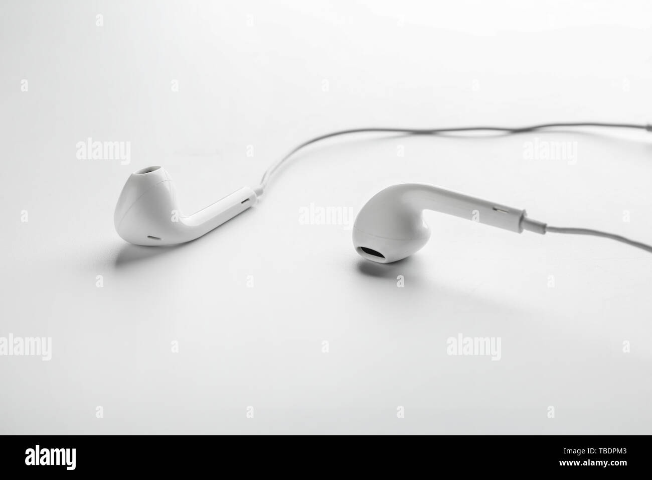 Modern earphones on white background Stock Photo - Alamy